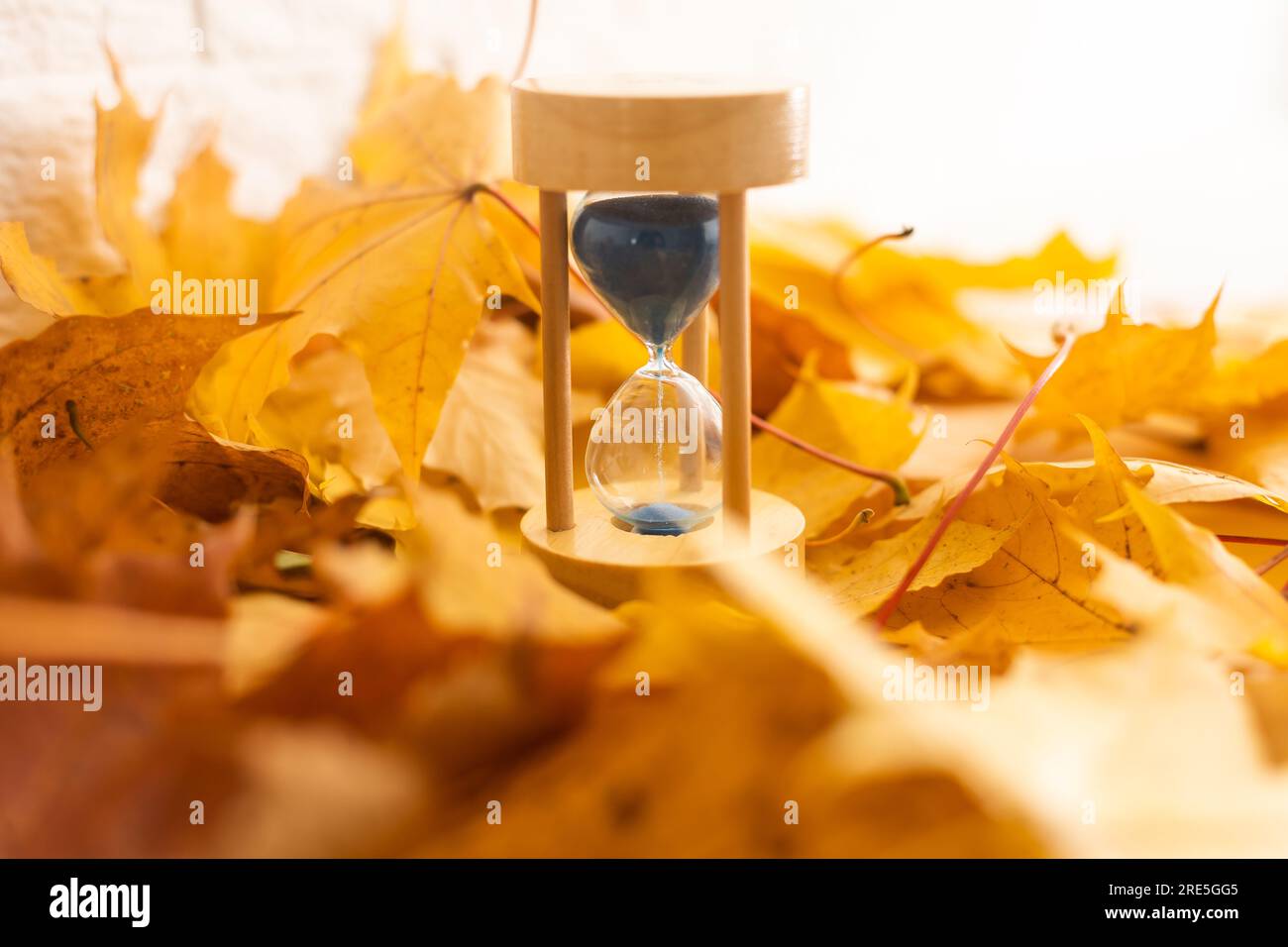 sand pours in an hourglass as a symbol of the passing summer and the ...