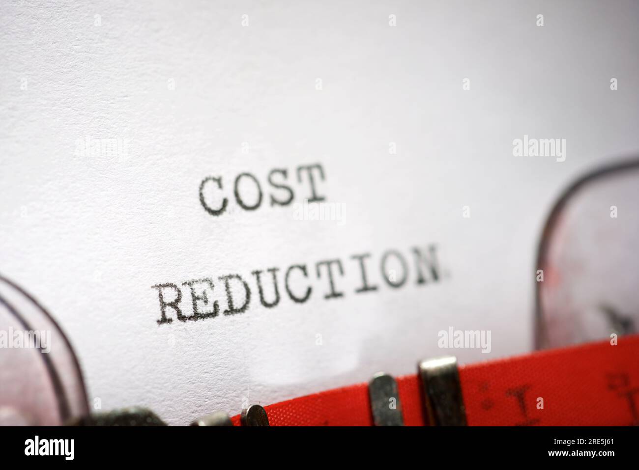 Cost reduction text written with a typewriter Stock Photo - Alamy
