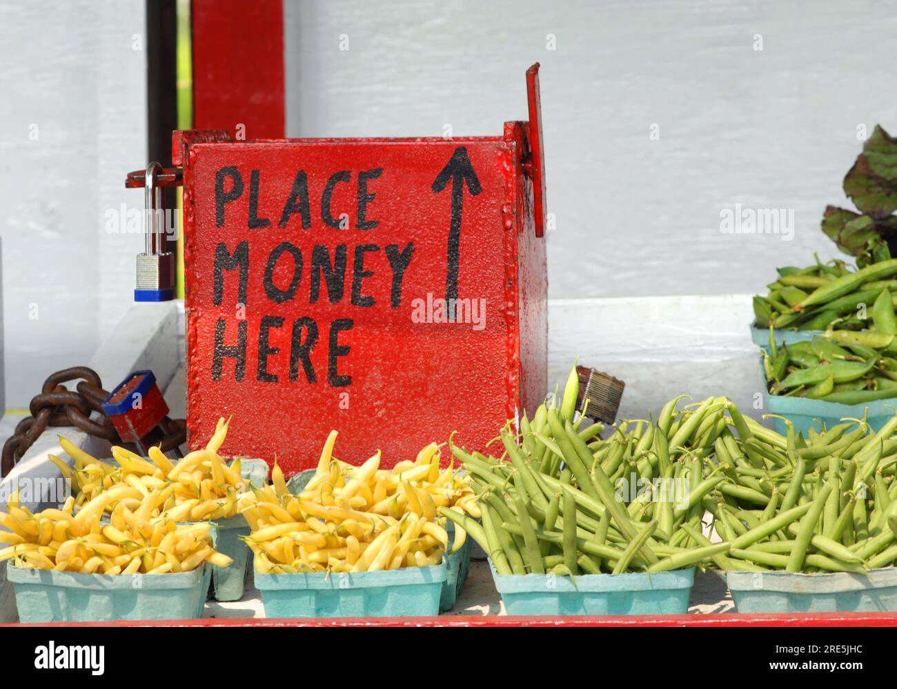 Amish roadside vegetable stand has steel, red painted, padlocked money ...