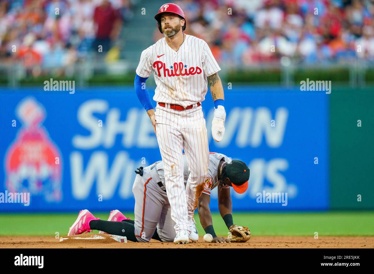Philadelphia Phillies' Jake Cave, left, looks on after his slide took ...