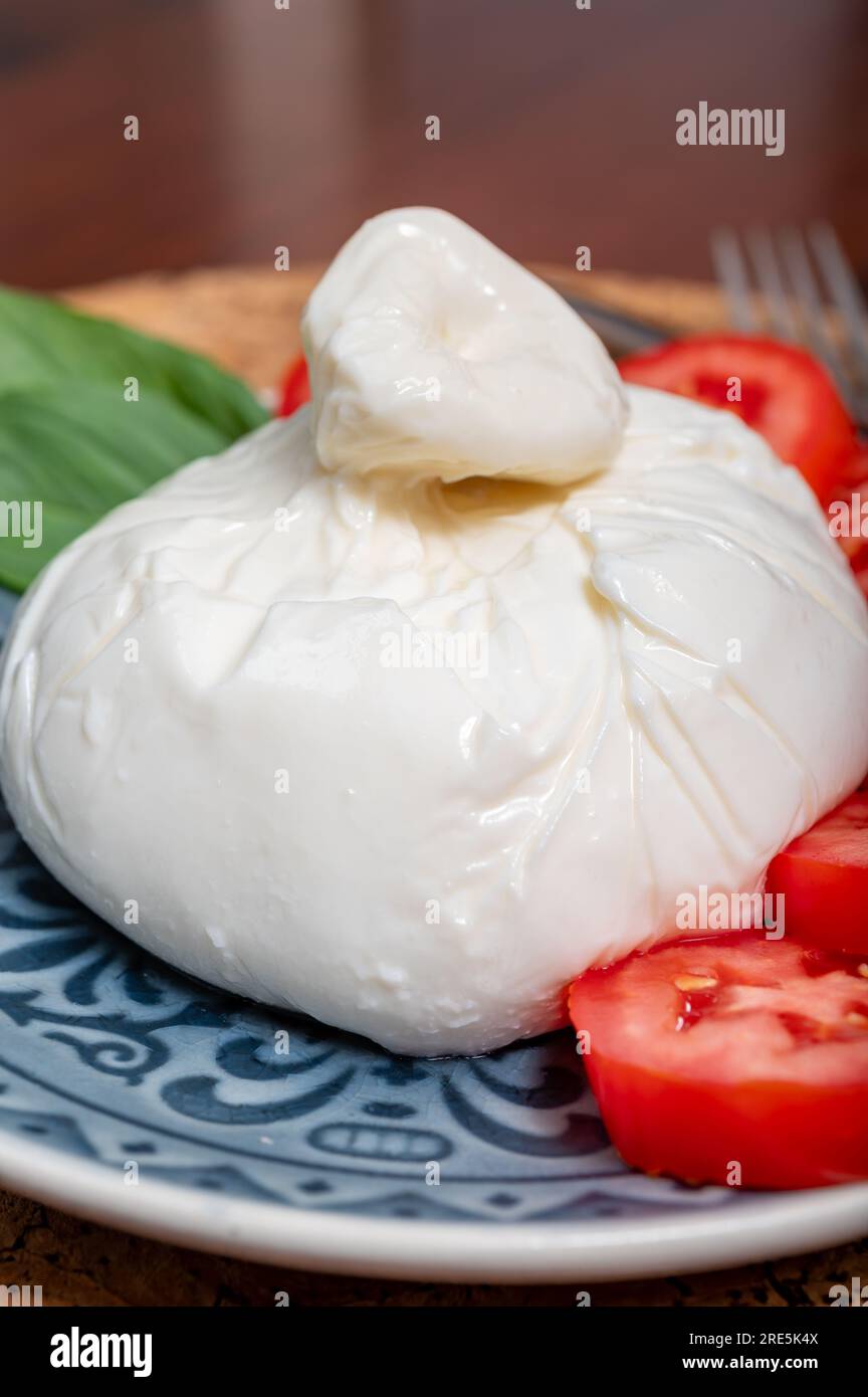 Fresh handmade soft Italian cheese from Puglia, white ball of burrata ...