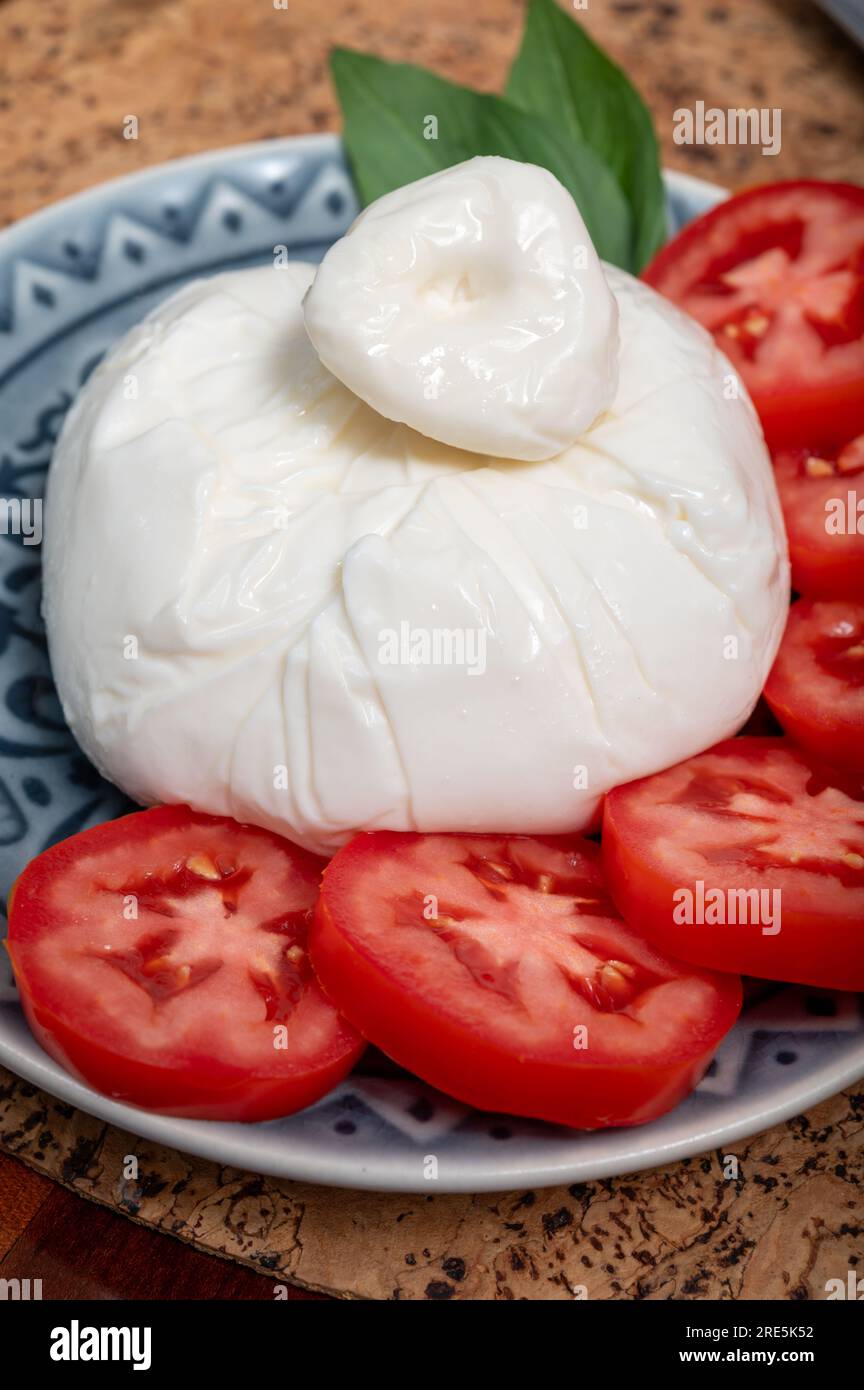 Fresh handmade soft Italian cheese from Puglia, white ball of burrata ...
