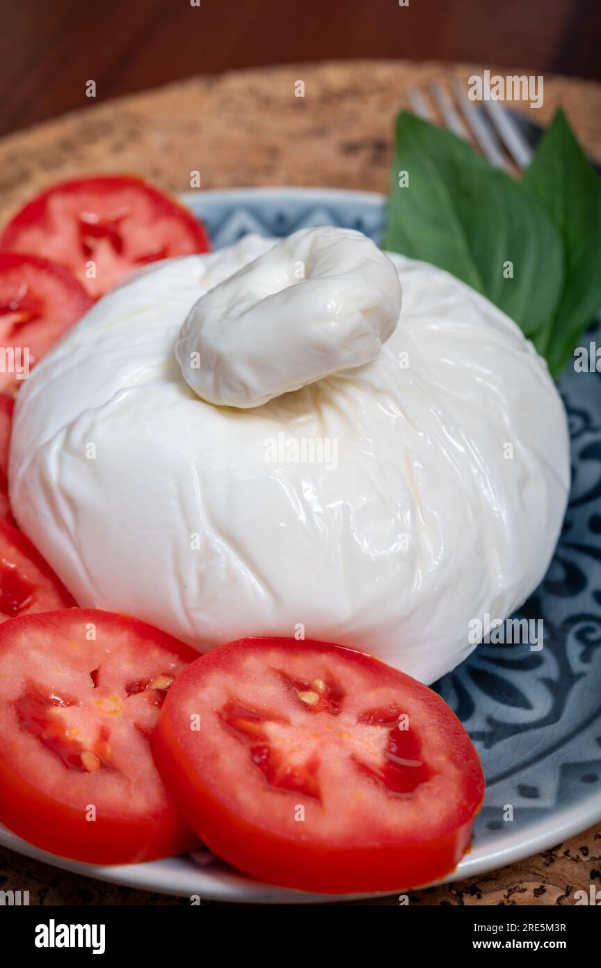 Fresh handmade soft Italian cheese from Puglia, white ball of burrata ...