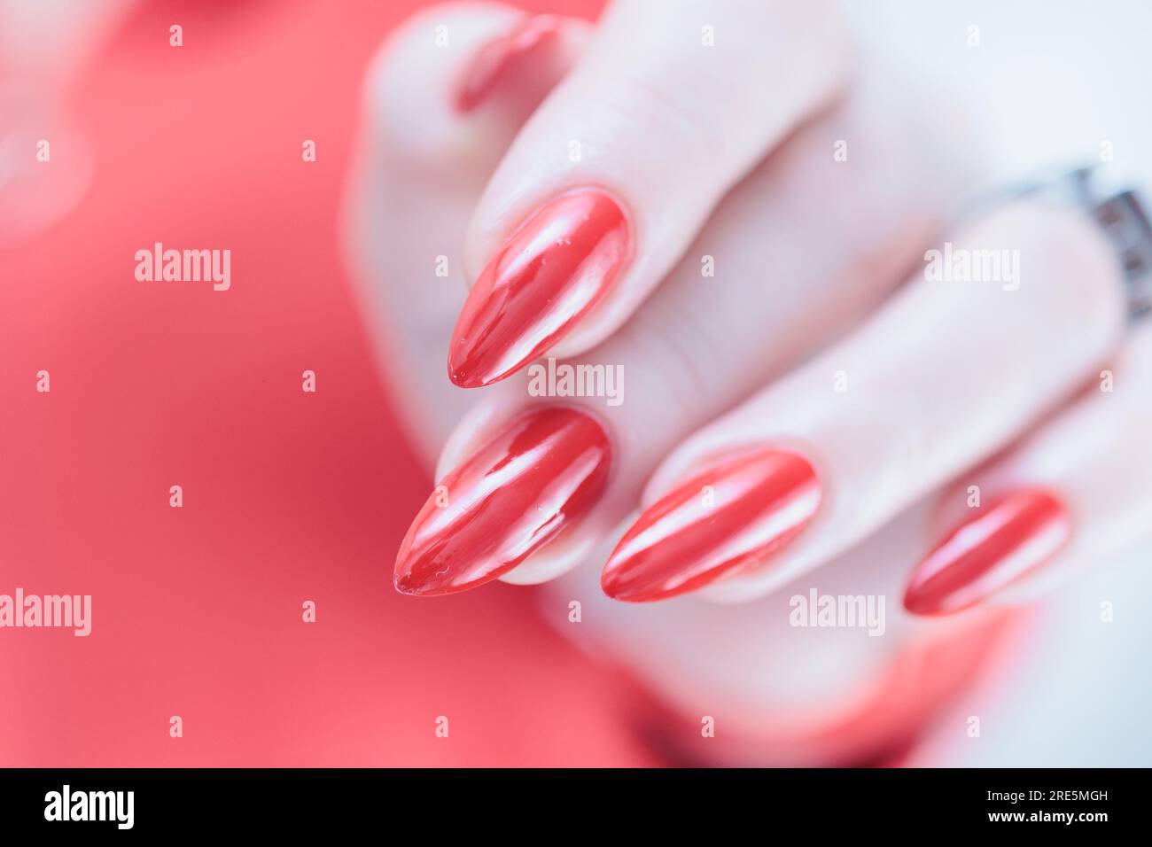Female hand with long nails and a bright red manicure Stock Photo - Alamy