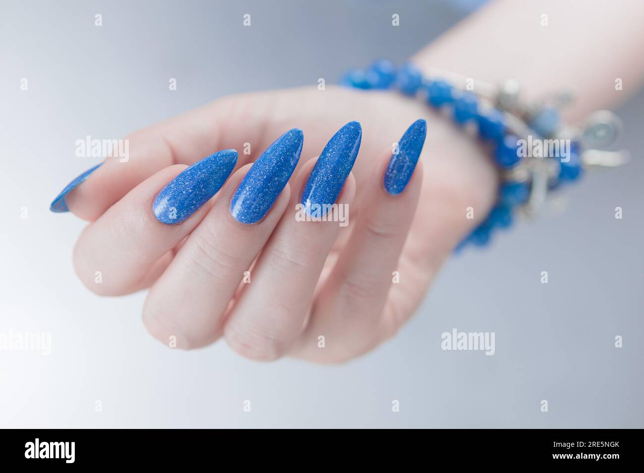 Woman's beautiful hand with long nails and light blue manicure Stock ...