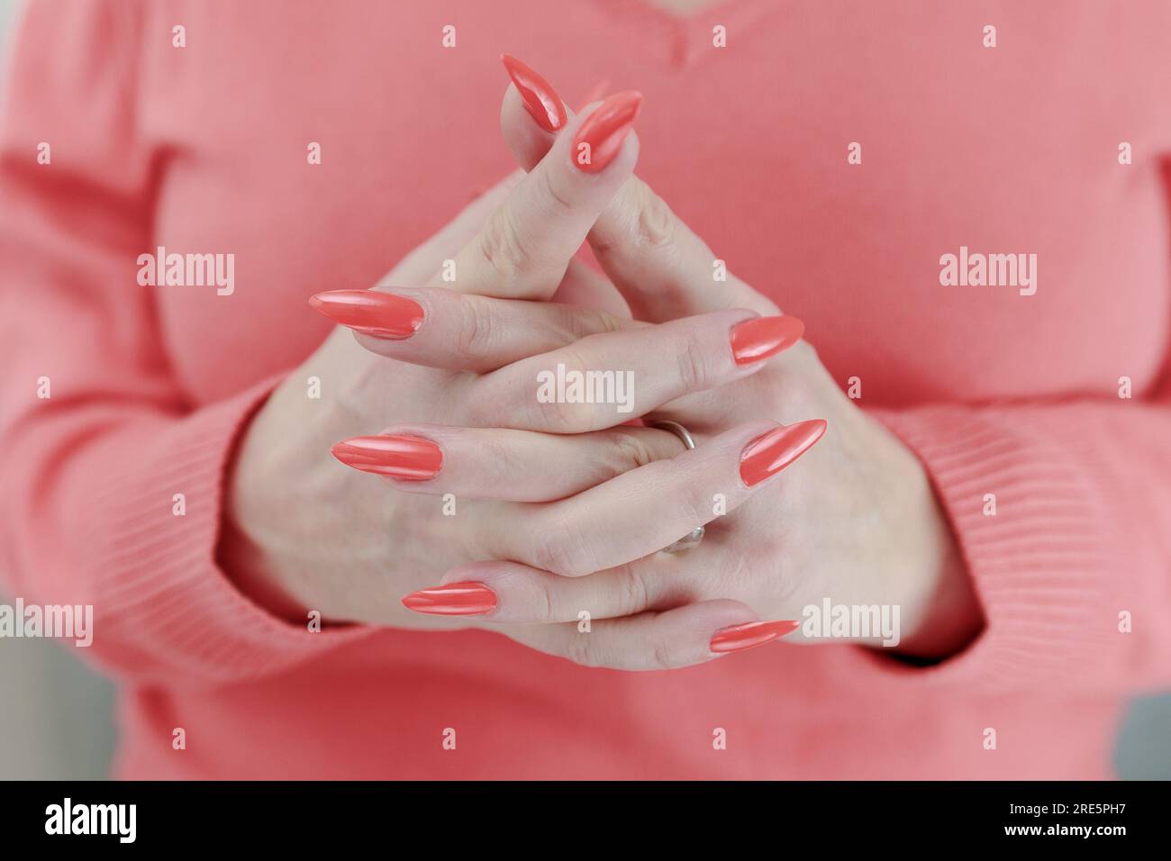 Hands of woman with long fingernails hi-res stock photography and ...