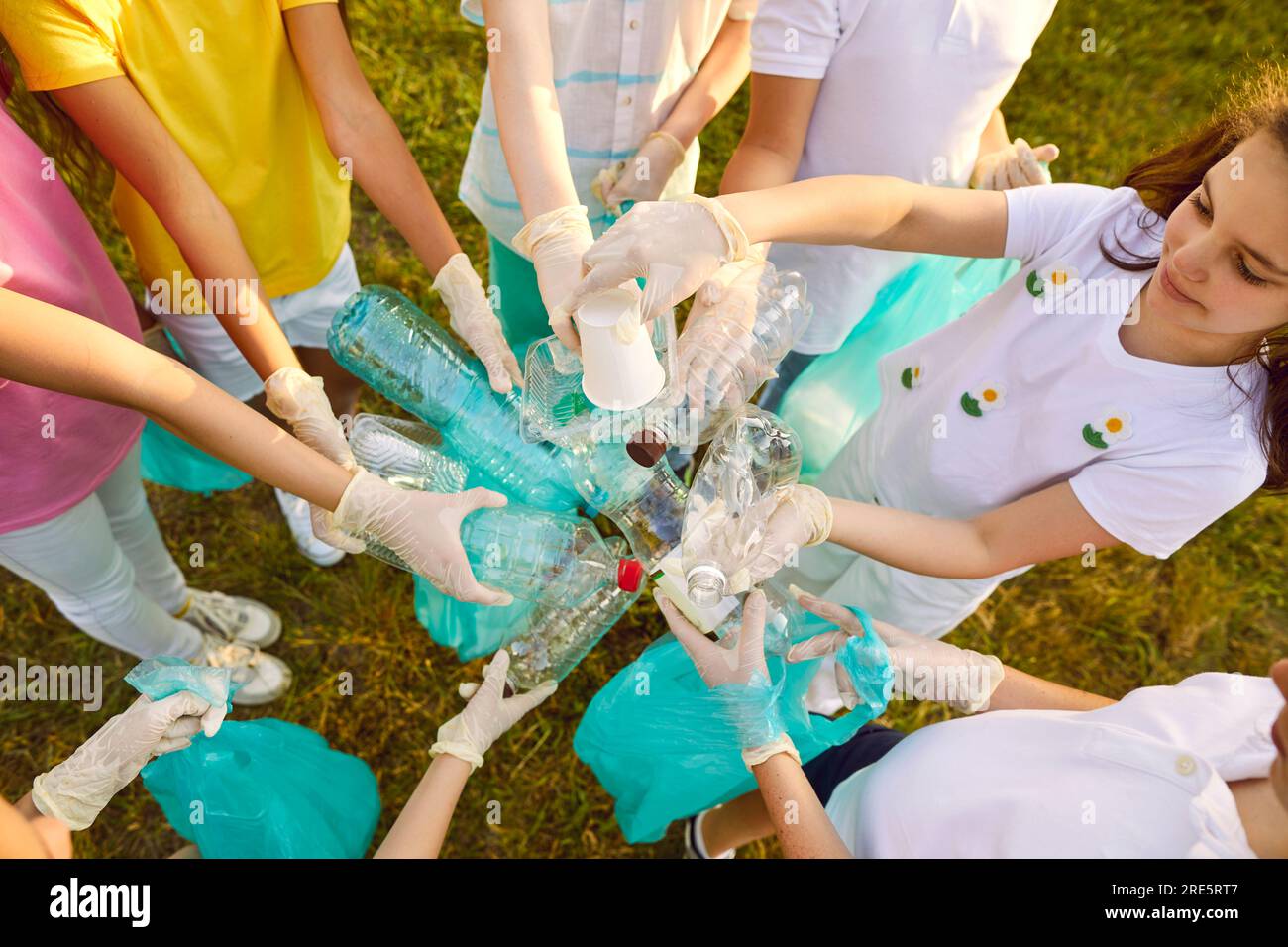 Top view of group of kids standing with garbage bags collecting plastic ...