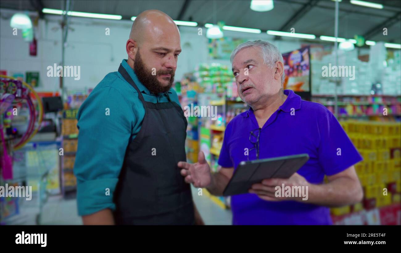 Supermarket manager addressing inventory hi-res stock photography and ...