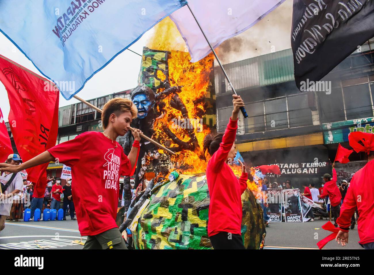 Quezon, Philippines. 24th July, 2023. Protesters with flags walk past ...