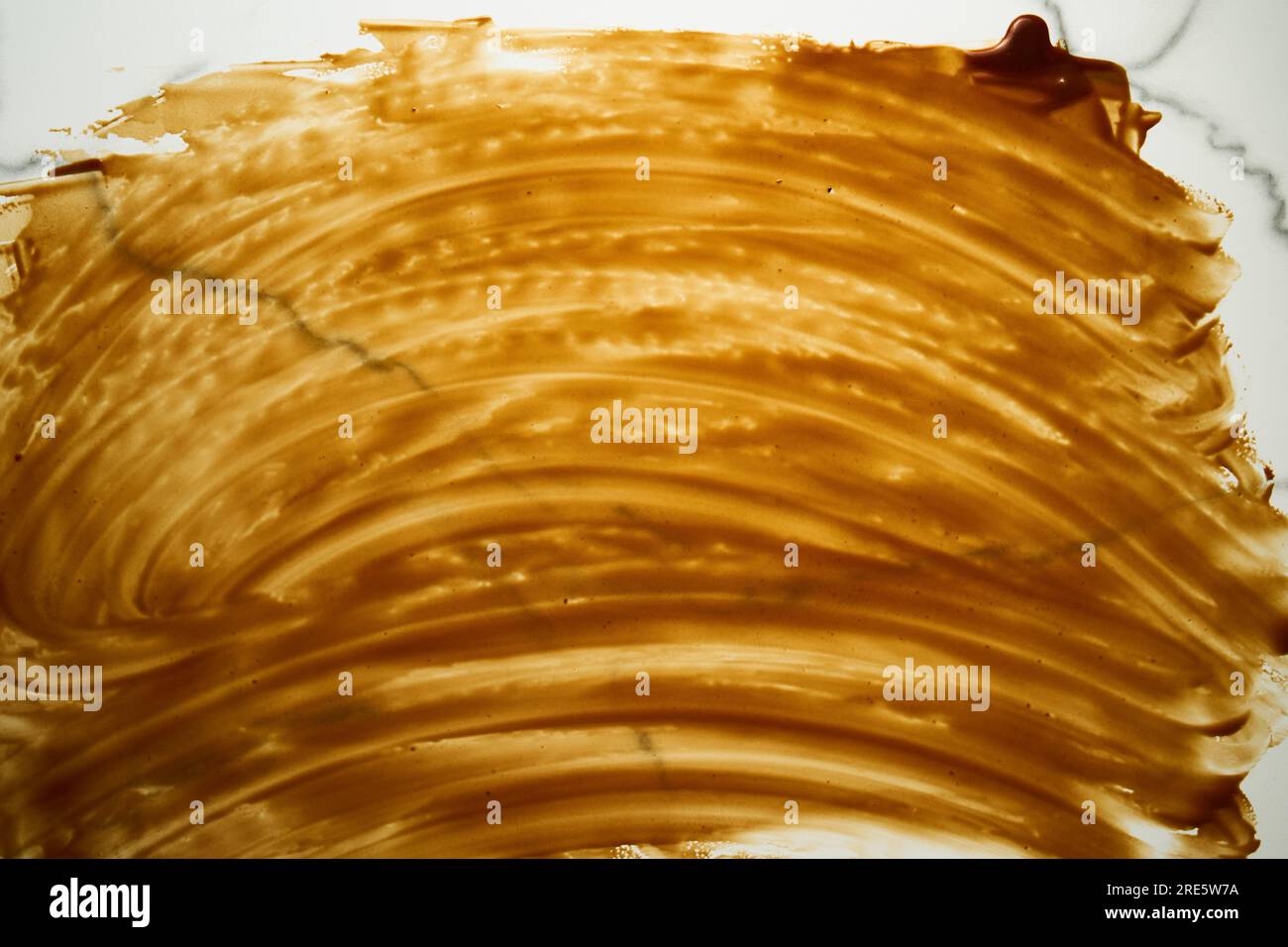 Salted Caramel sauce smeared on the tabletop. A tabletop stained with ...