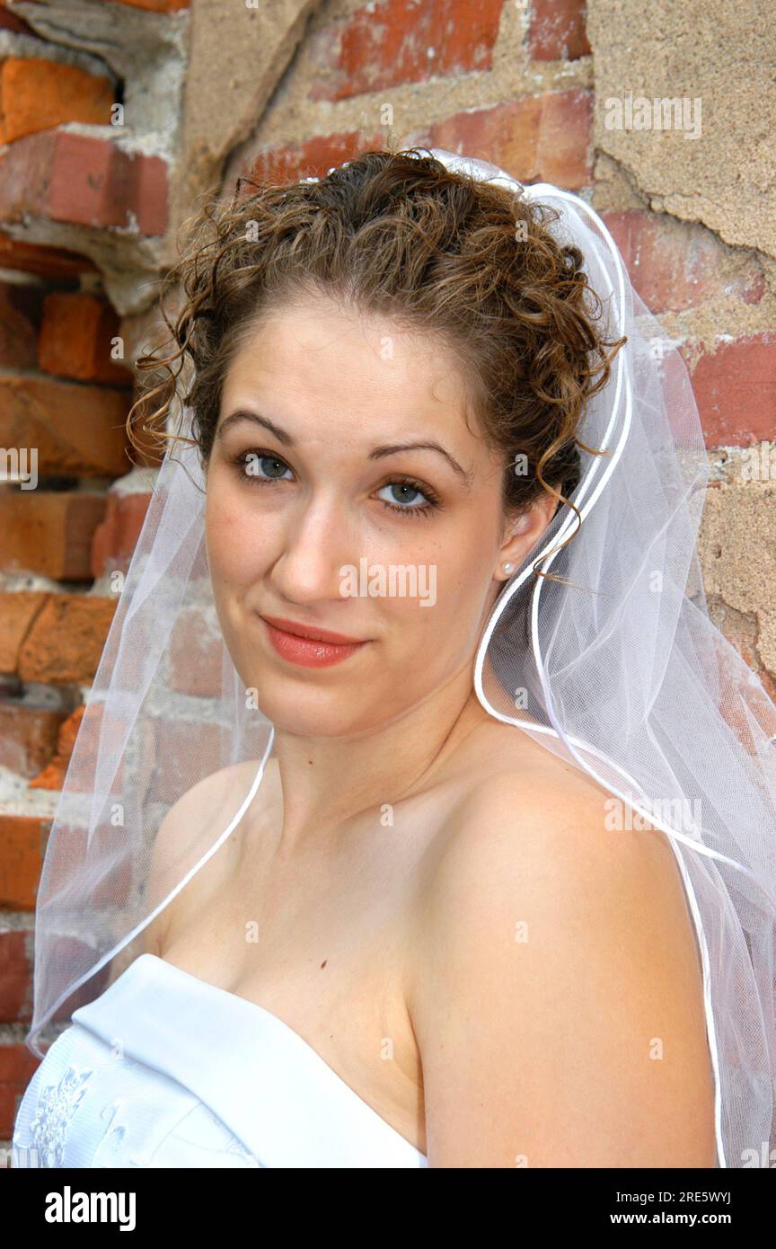 Rustic brick wall serves as a background for beautiful bridge to lean ...