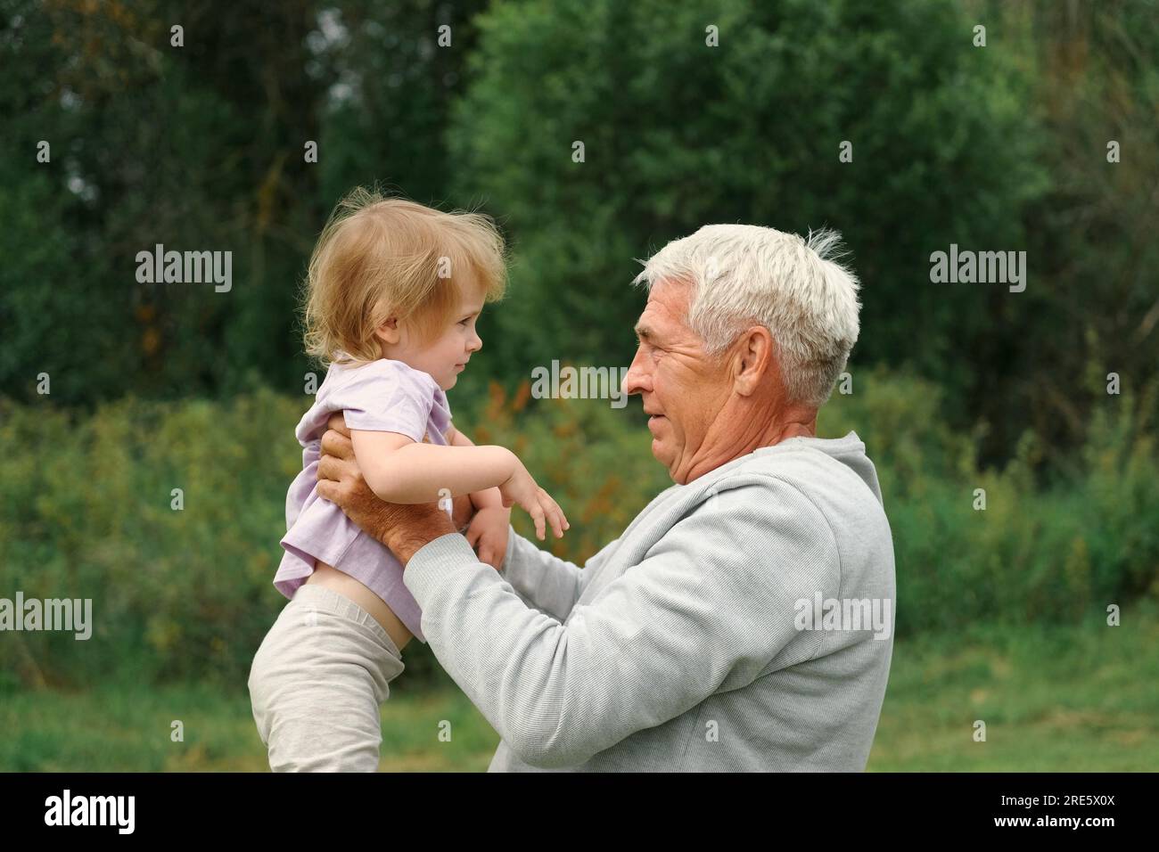 Grandfather and grandchild baby have fun during walk In Park. Happy ...