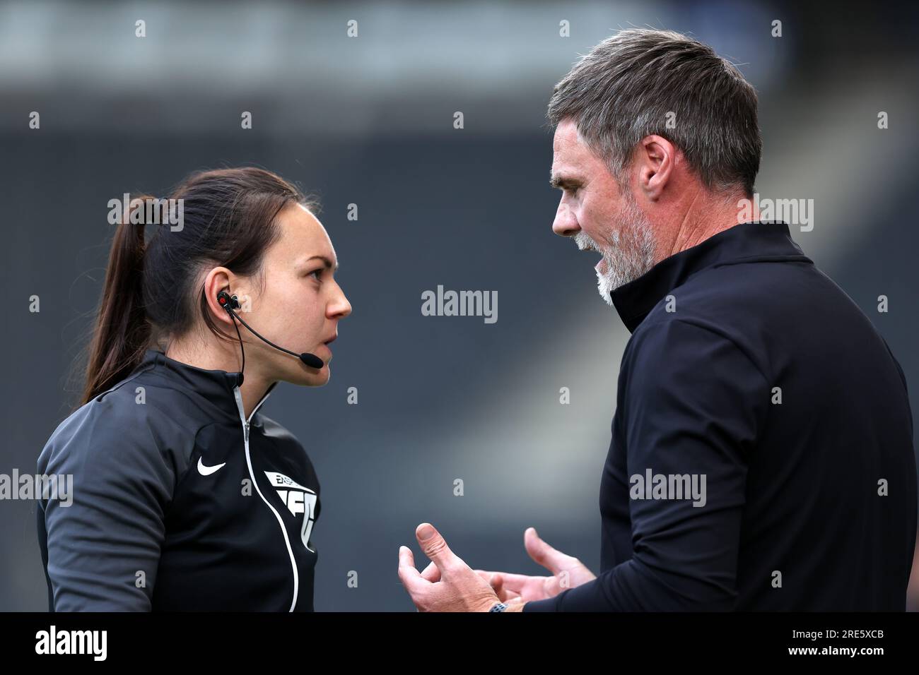 Milton Keynes Dons manager Graham Alexander (right) speaks to fourth ...