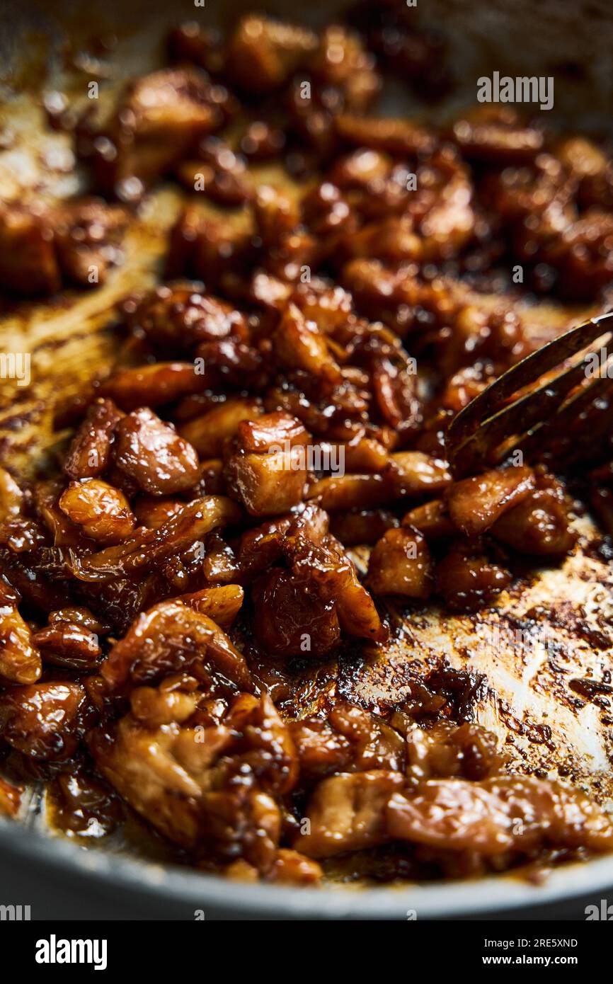 Chicken Tocino. Chicken in gooey sweet glaze in the wok. Caramelized ...