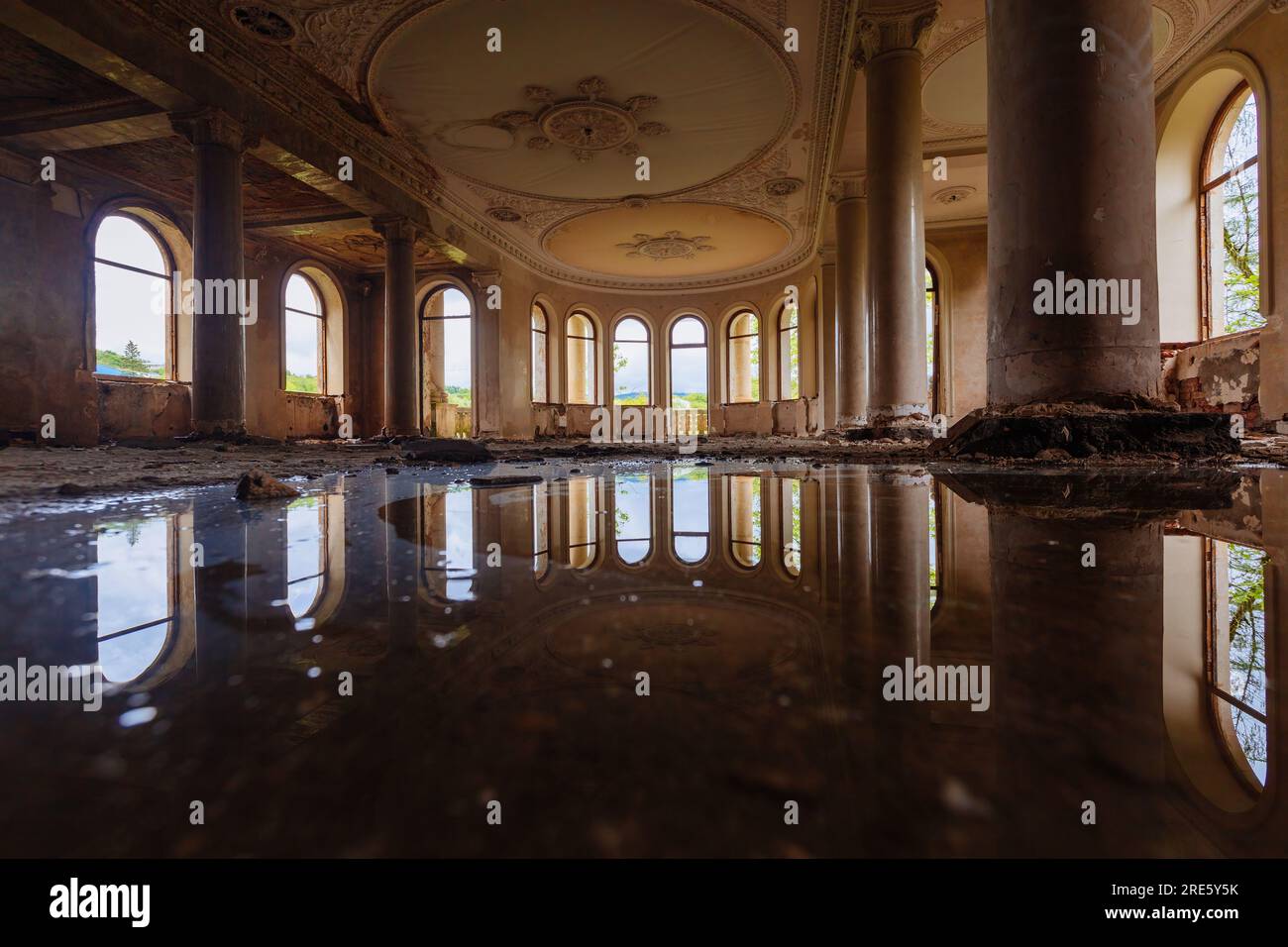 Flooded large hall with columns in old abandoned mansion, water ...