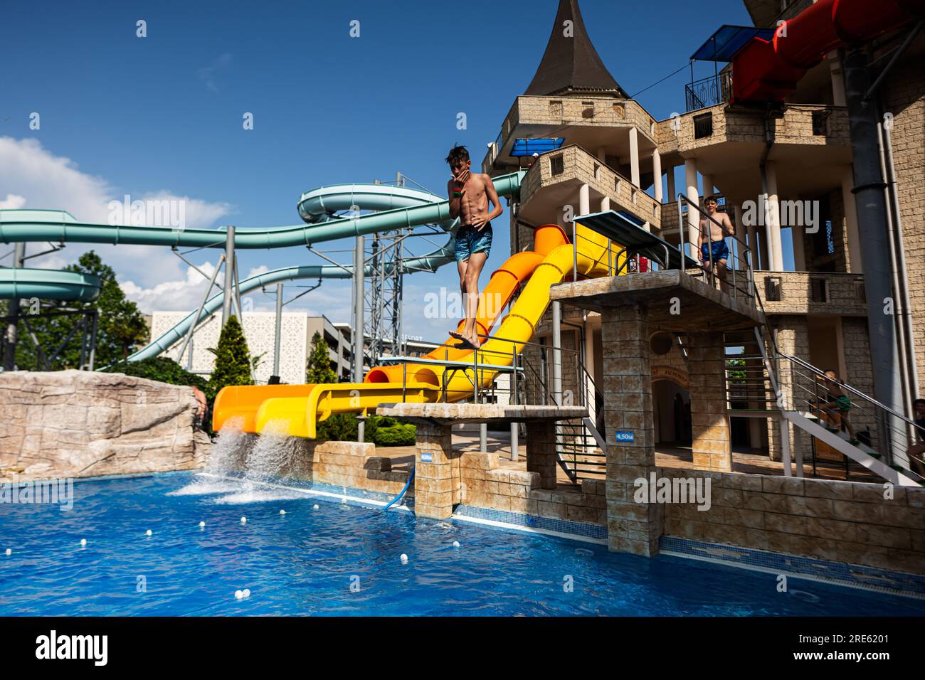Young boy jump and having fun on a water slide in an aquapark Stock ...