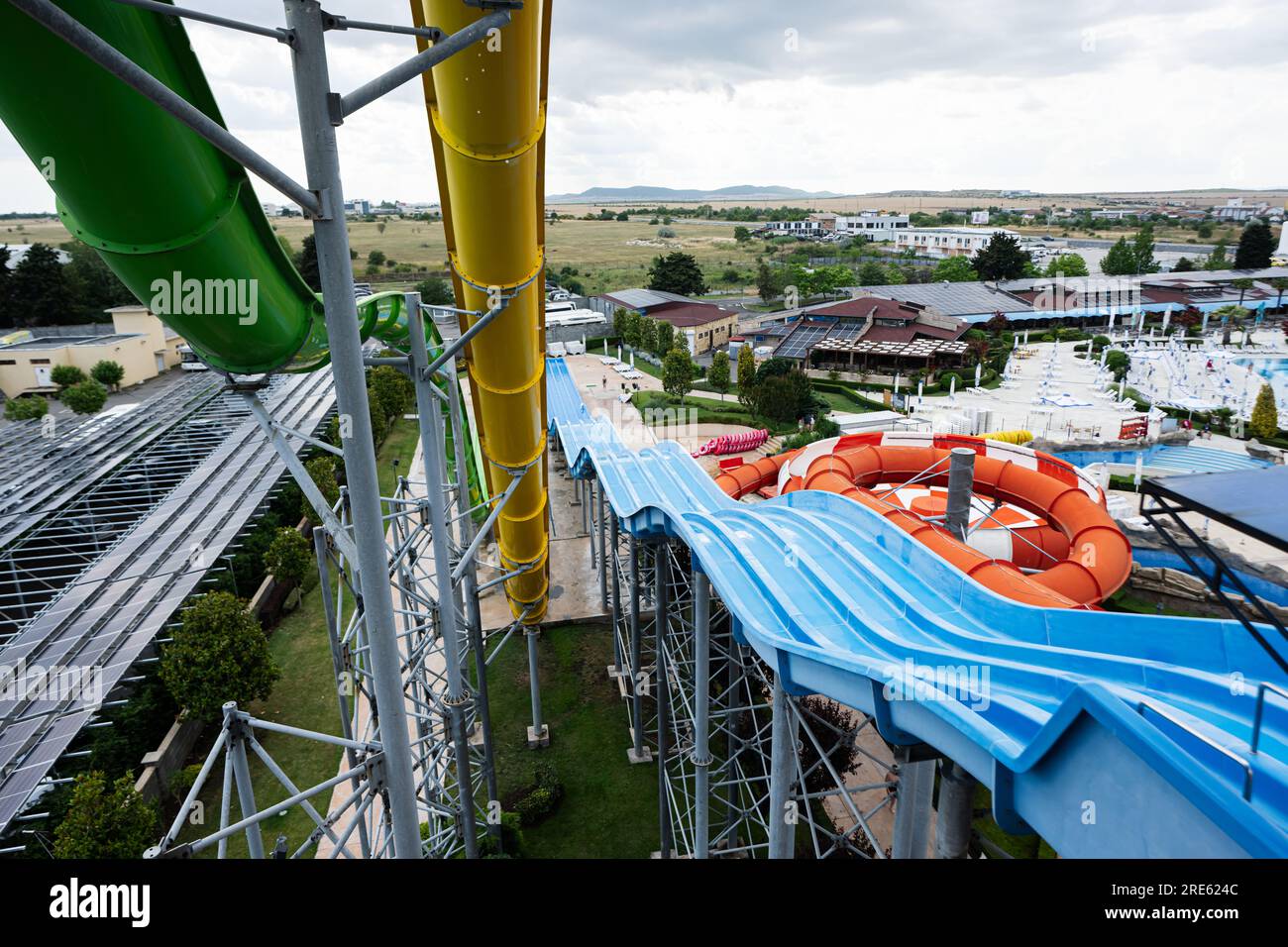 Aerial view of water park with blue and yellow water slide at summer ...