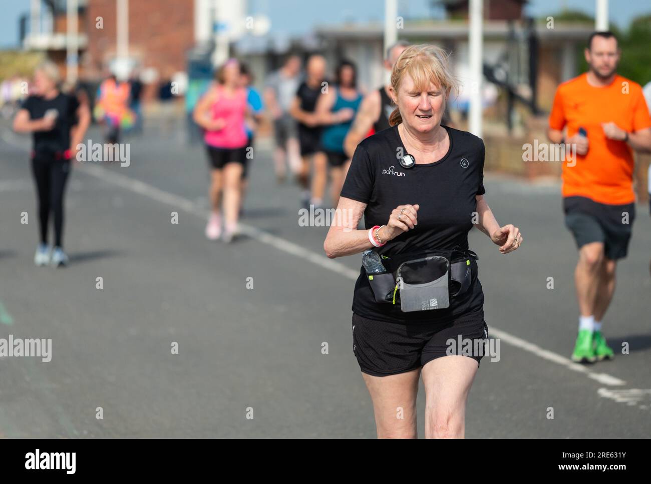 Runners at the weekly Parkrun (Park Run), a community event, running ...