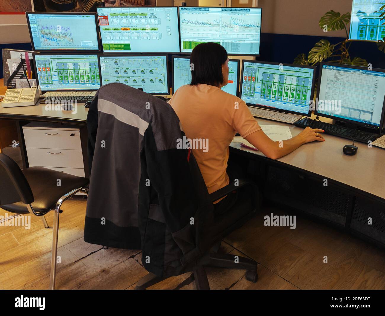 Operator working in control room of factory Stock Photo - Alamy