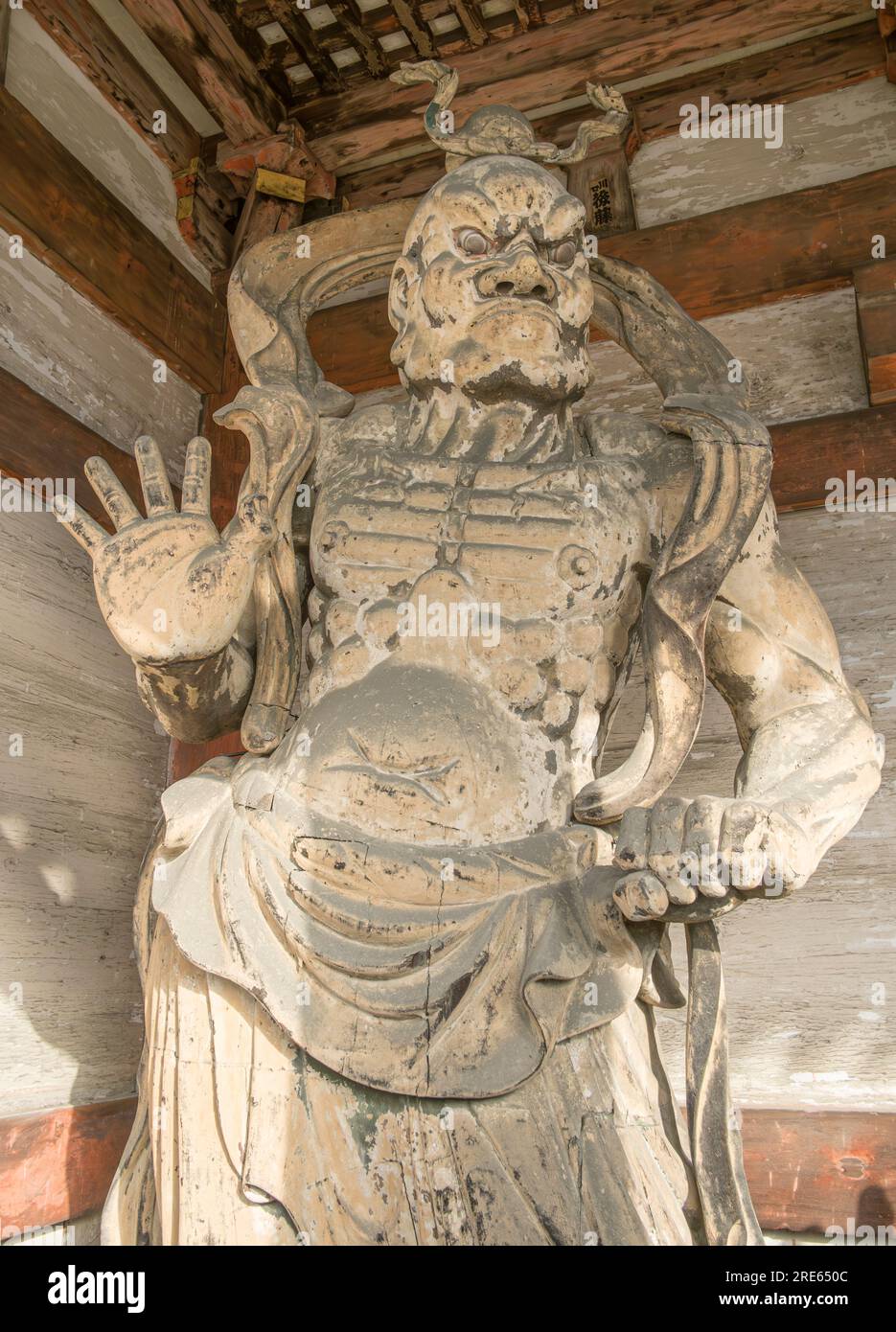 A statue of a demon guarding a gate at Ninnaji, a Buddhist temple in ...