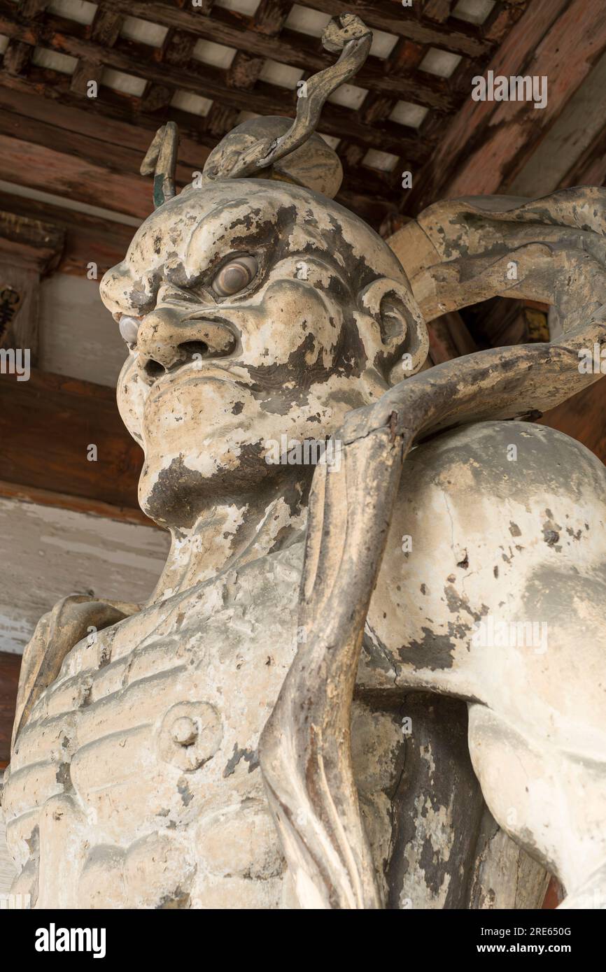 A statue of a demon guarding a gate at Ninnaji, a Buddhist temple in ...