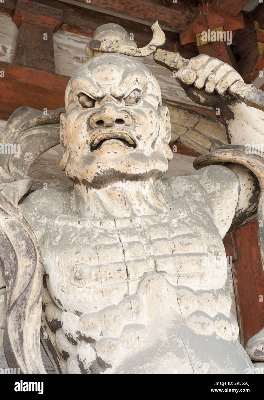 A statue of a demon guarding a gate at Ninnaji, a Buddhist temple in ...