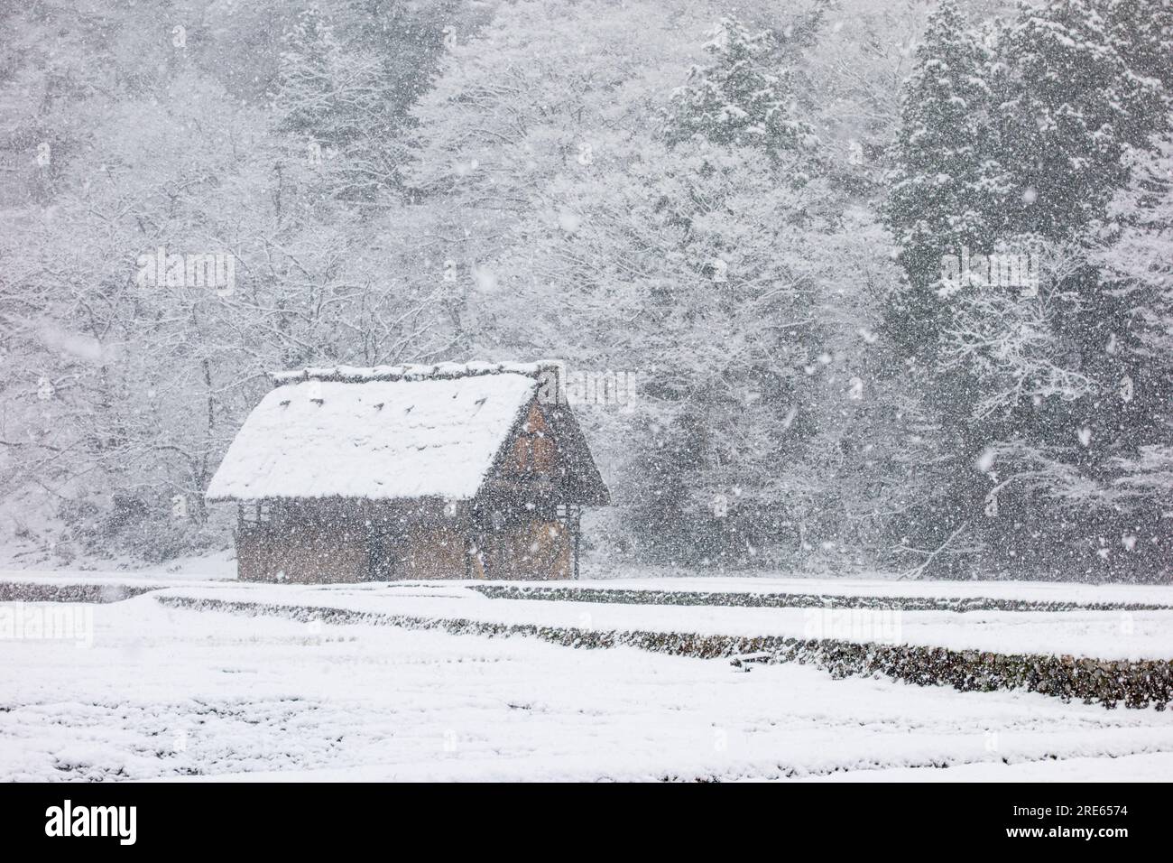A traditional thatched roof barn in snow in the historic village of ...