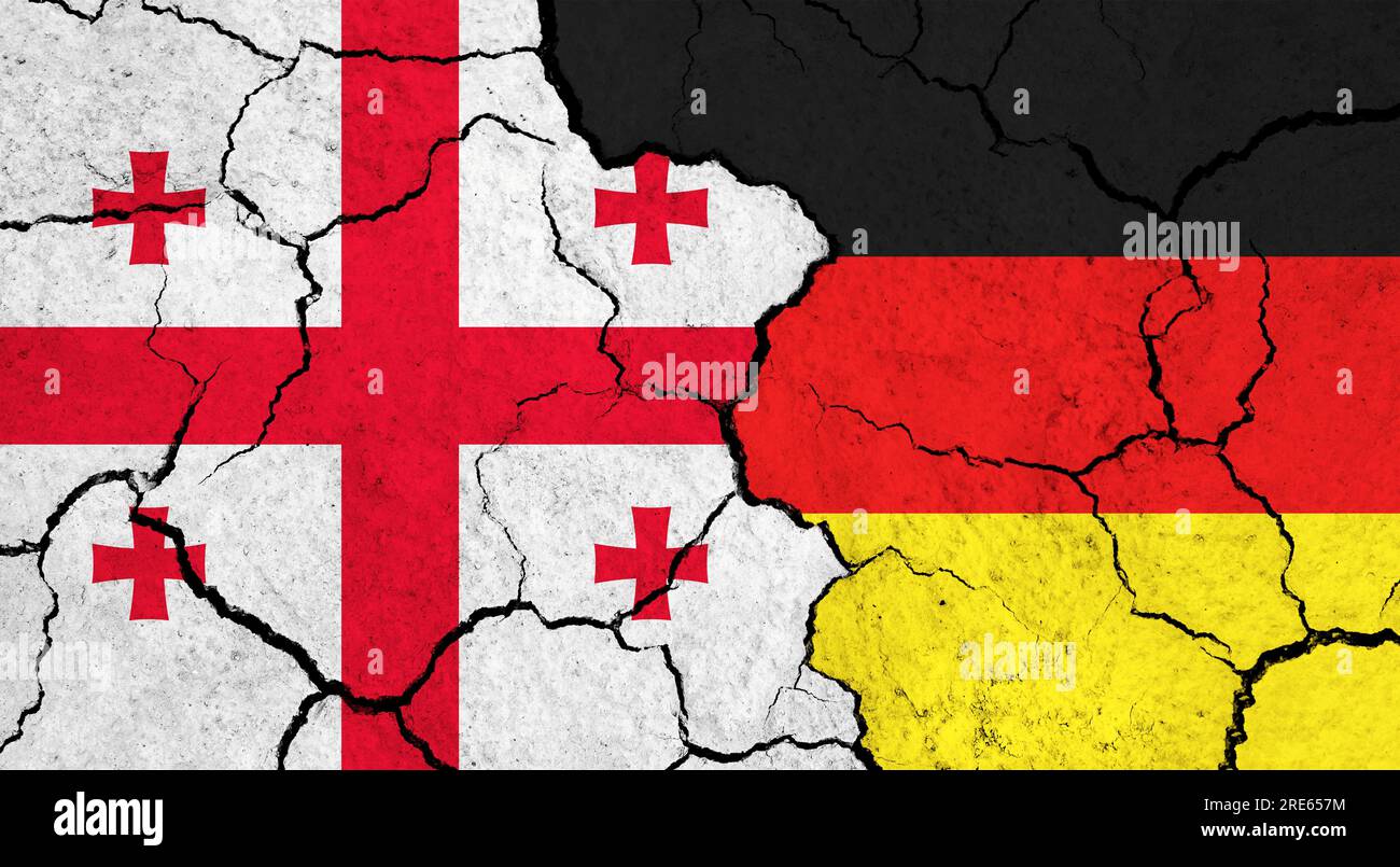 Flags of Georgia and Germany on cracked surface - politics ...