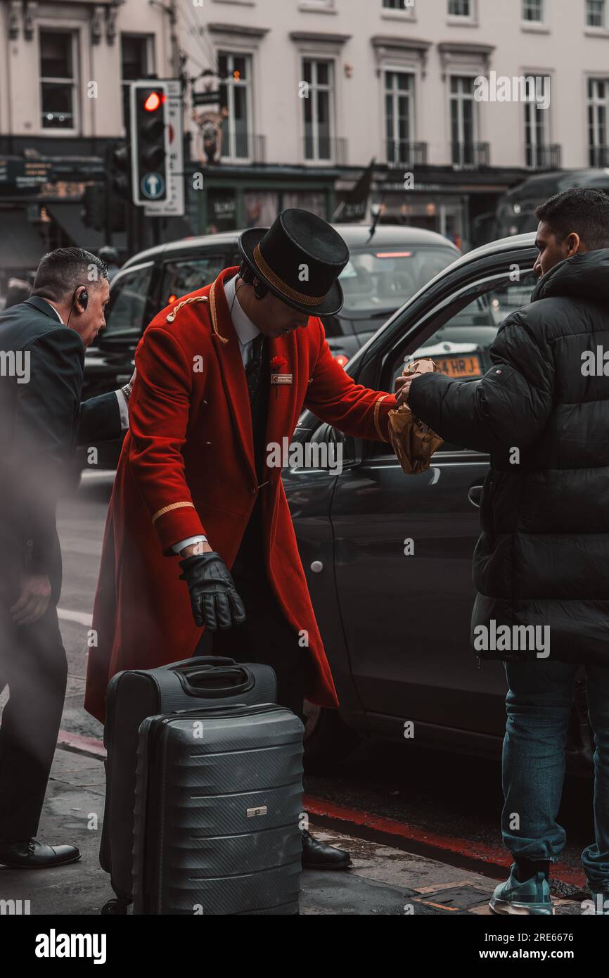 Hotel in London, Portrait of an Porter in London, in a handsome red ...