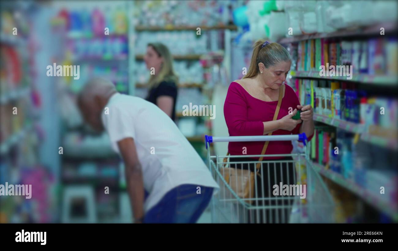 Customer shopping at grocery store isle. Diverse people searching for ...