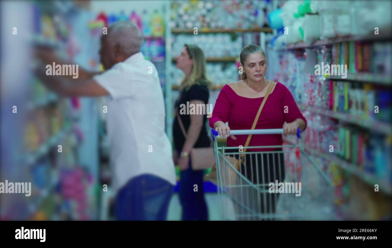 Customer shopping at grocery store isle. Diverse people searching for ...