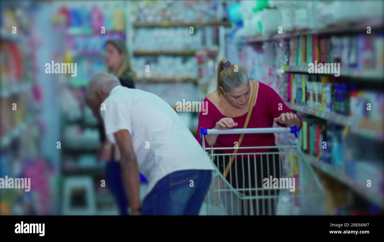 Customer shopping at grocery store isle. Diverse people searching for ...