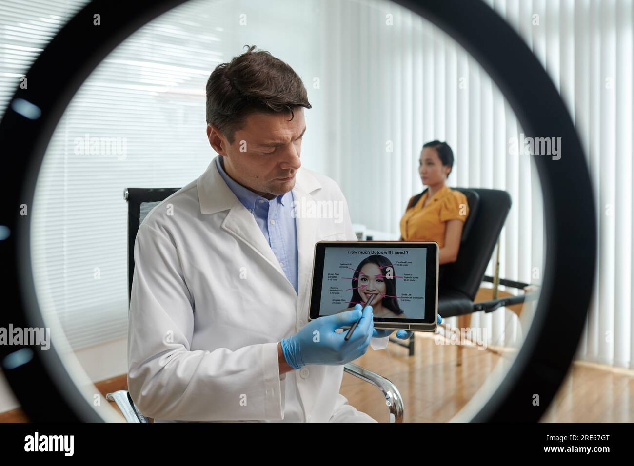Doctor pointing at chart on tablet computer explaining how to much ...