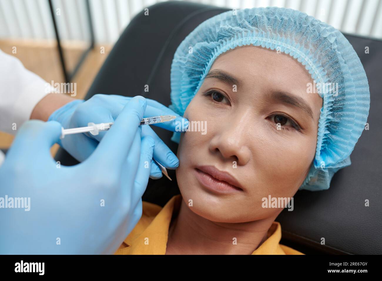 Young Asian woman getting beauty injections for facelift and ...