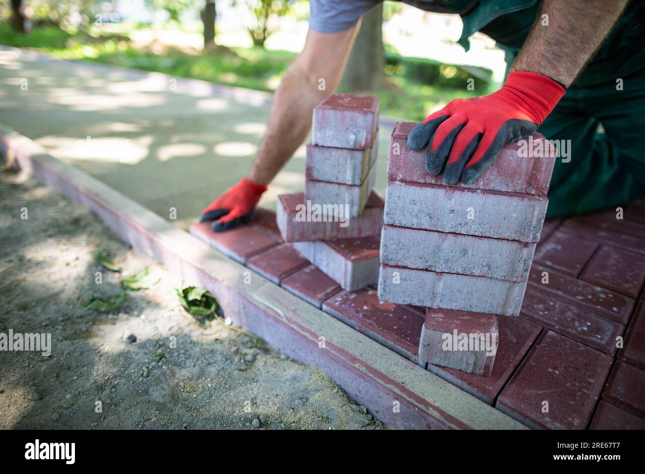 Paving work for laying a new pedestrian path is being done in the ...