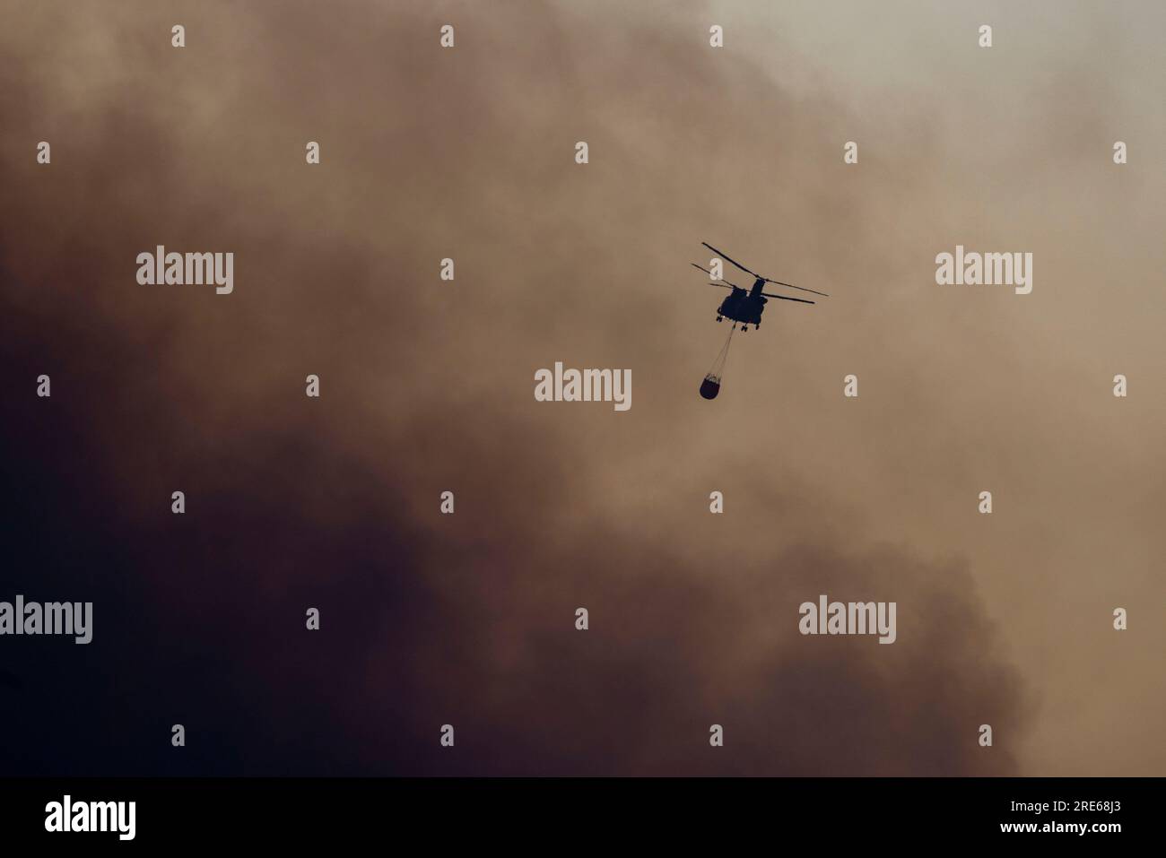 Greece. 25th July, 2023. A Chinook helicopter flies through the fire ...