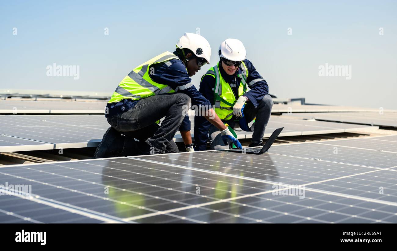 Engineers with safety helmet checking solar system at solar power farm ...