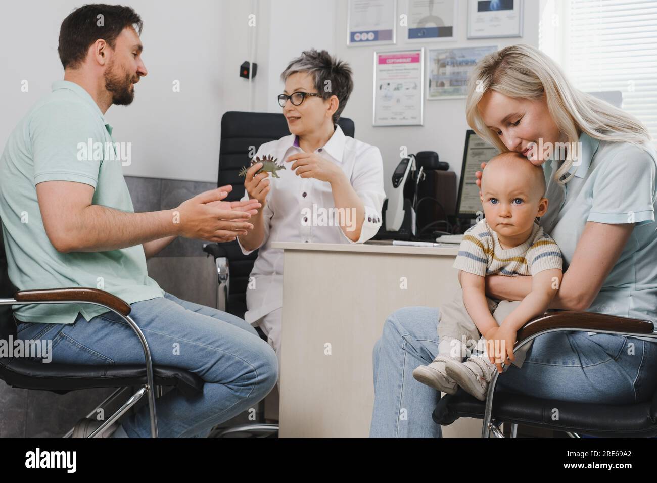 Family at kids hearing check-up. Parents with infant child consulting ...
