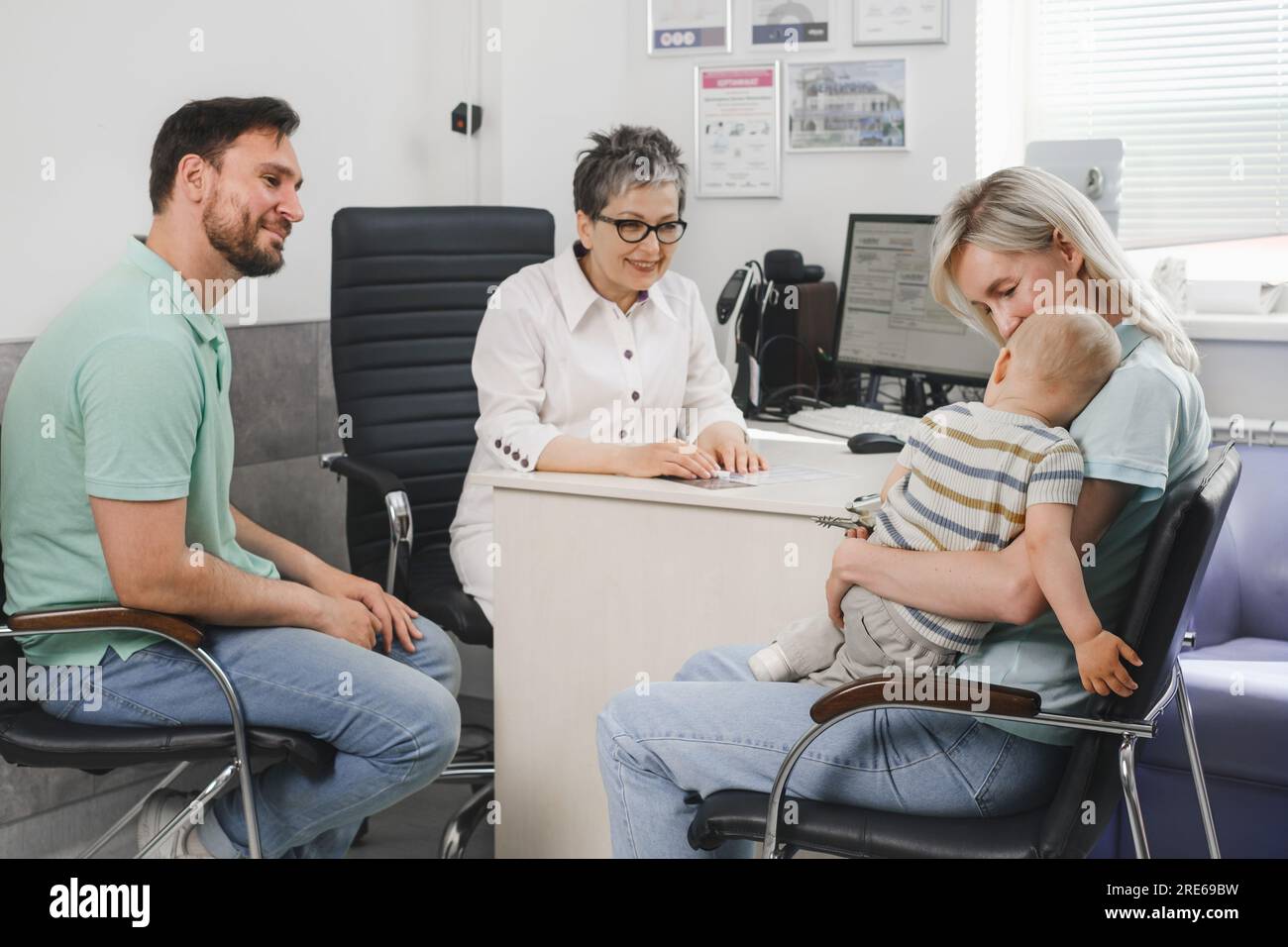 Family at kids hearing check-up. Parents with infant child consulting ...