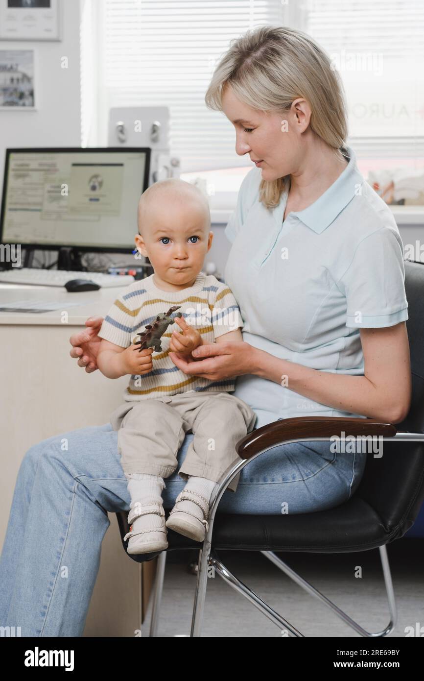 Woman with child consulting doctor for checkup. Parent with infant kid ...