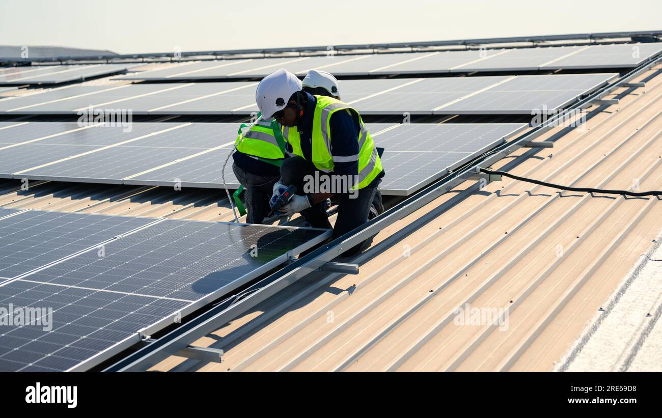 Engineers with safety helmet checking solar system at solar power farm ...