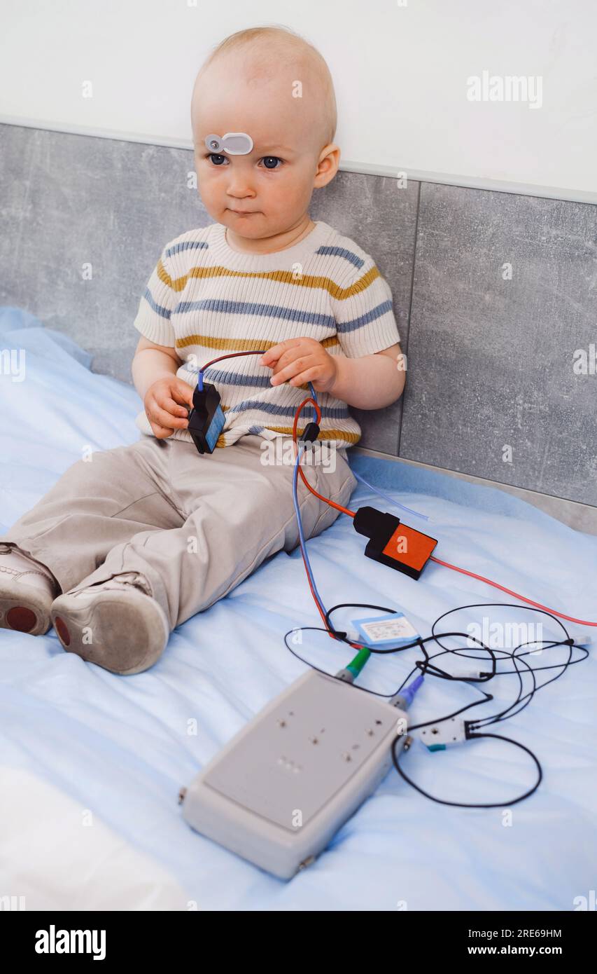 Child having hearing exam at otolaryngologist. Examining little patient ...