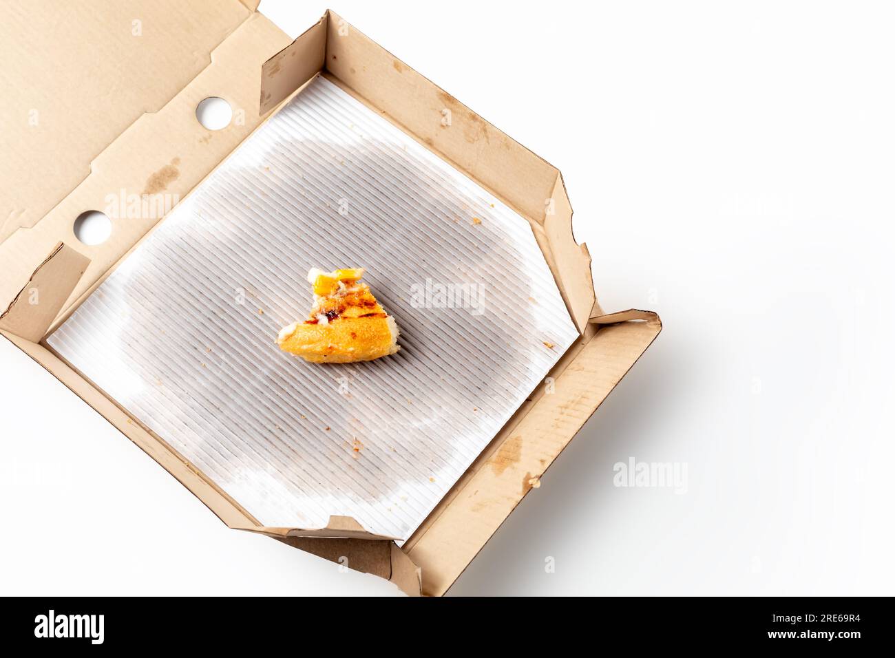 Leftover corn pizza in an open cardboard pizza box isolated on white ...