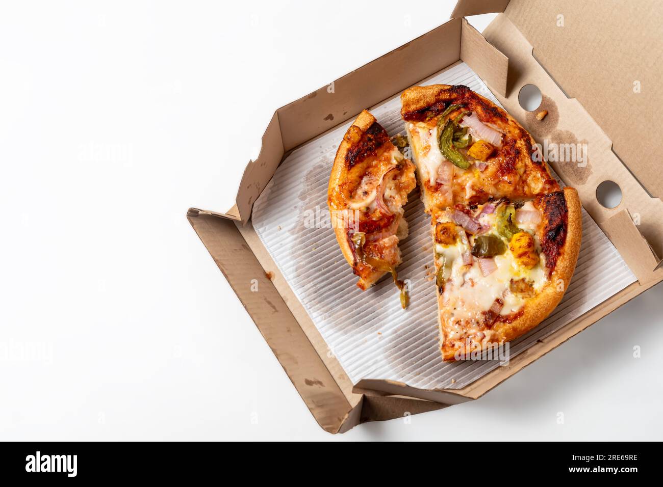 Leftover pizza in an open cardboard pizza box isolated on white ...