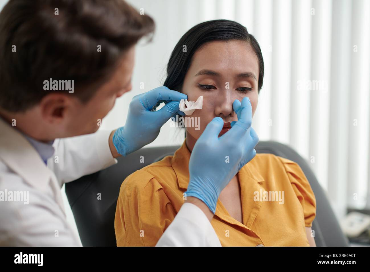 Plastic surgeon examining nose of patient after rhinoplasty Stock Photo ...