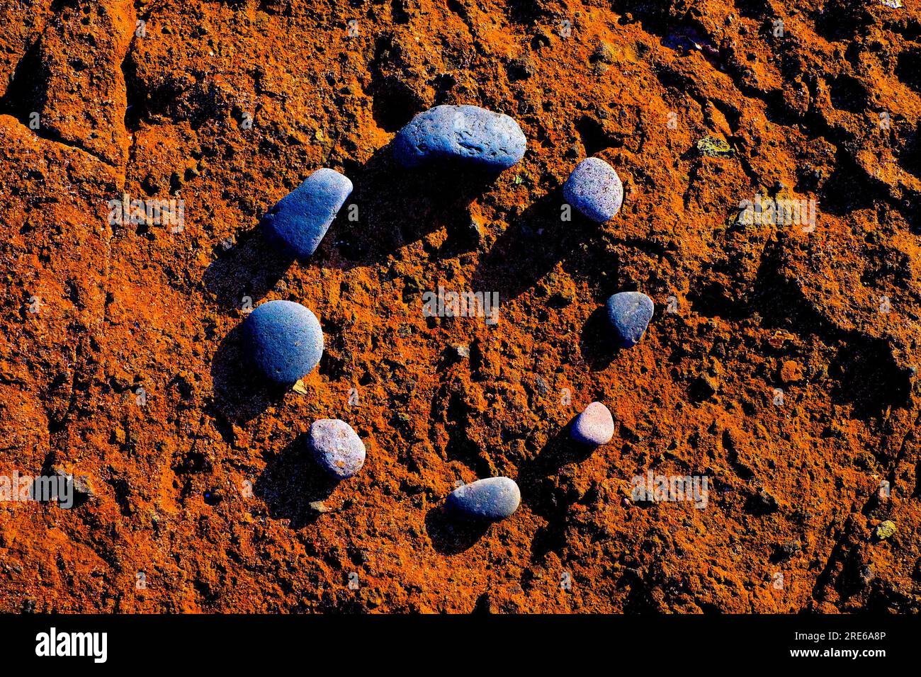A small ring of blue stones on a red rocky surface, a simple symbol of ...