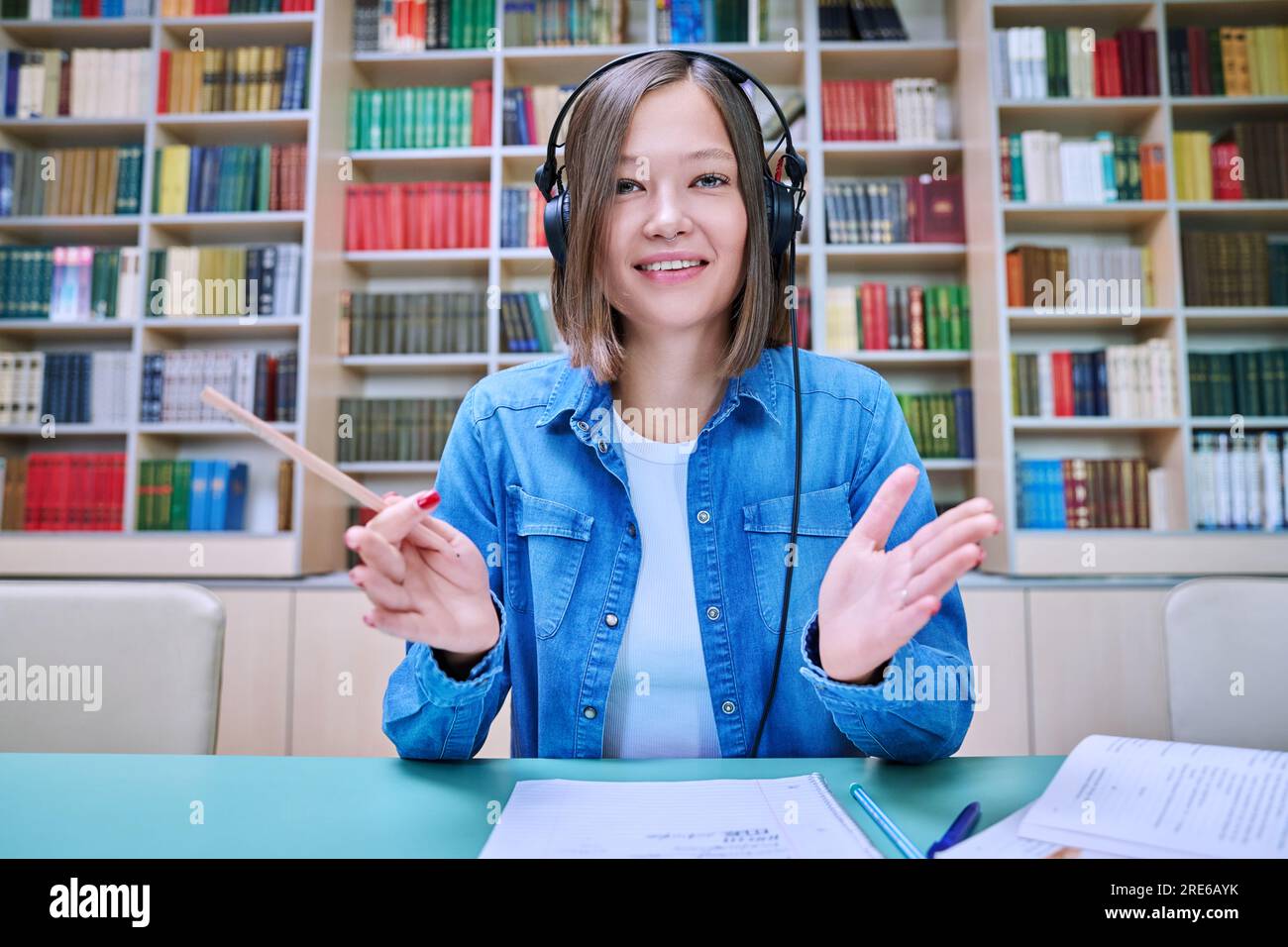 Close-up webcam view of face female student, inside university library ...
