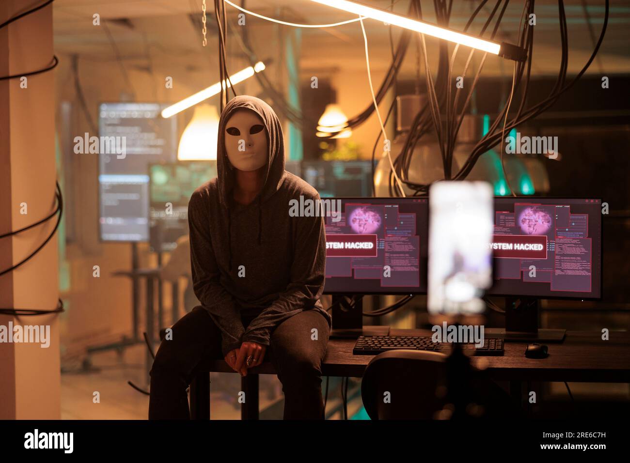 Young Hacker With Anonymous Mask Attacking Computer Server Committing