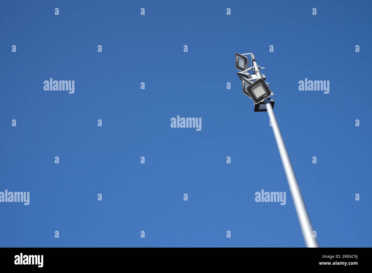 A lamp post with LED beam reflectors on empty vast blue sky Stock Photo ...