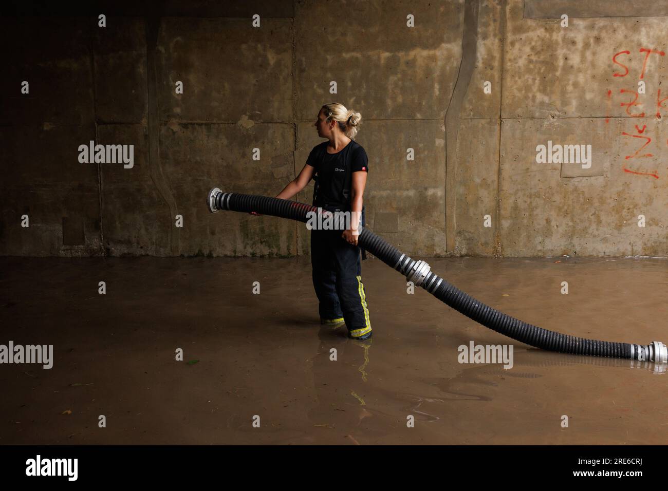 A firefighter prepares a pump to pump water from a flooded underpass in ...